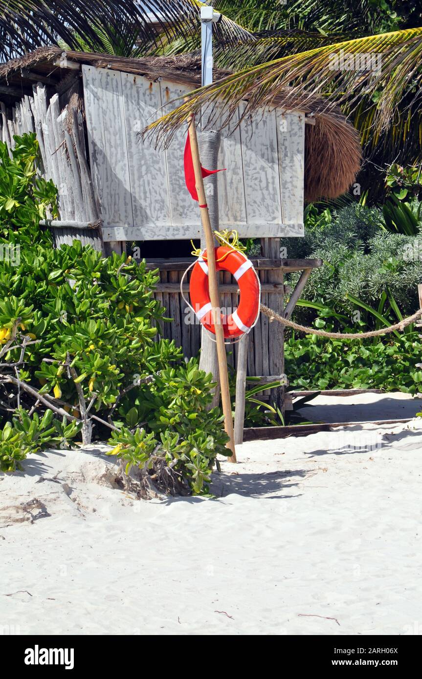 A Life Ring and a Lifeguard flag in front of a Lifeguard hut on the ...