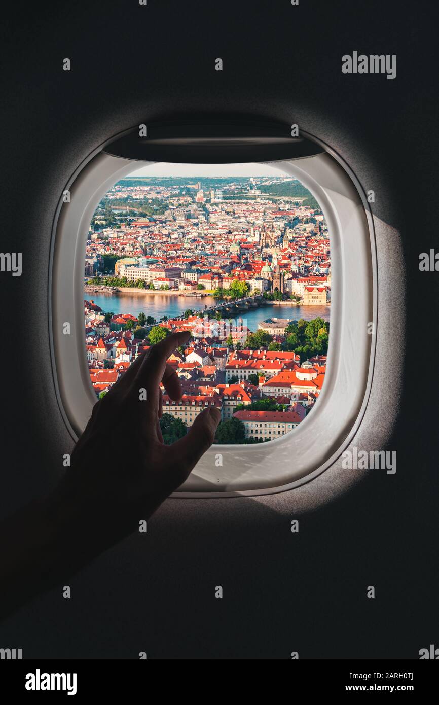 Airplane window with a aerial panorama of Prague, Czech Republic during ...