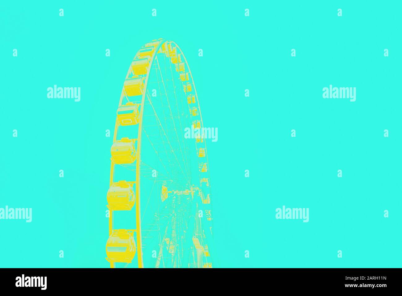 Yellow ferris wheel on a aqua menthe color background. Minimal concept ...