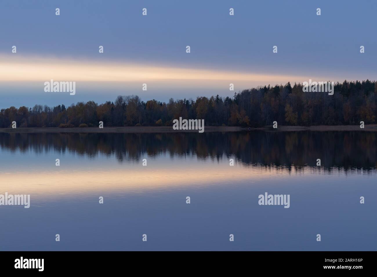Serene landscape. Sunset on the lake, calm water surface, symmetrical ...