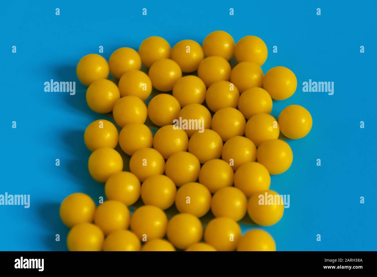 Yellow vitamins on a blue background. Vitamin complex against the virus ...