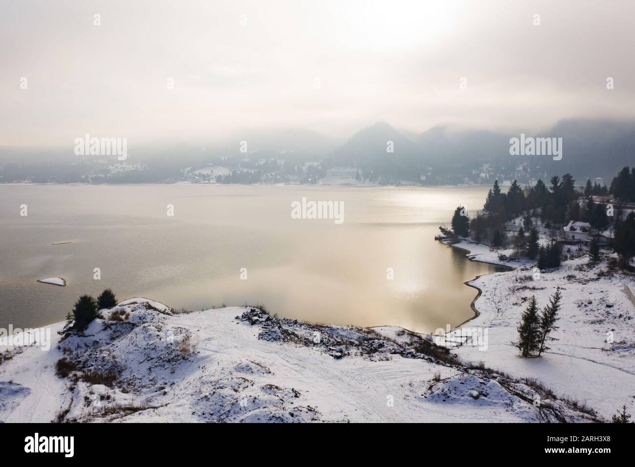 Winter magic landscape with scenic frozen mountain lake at Colibita ...