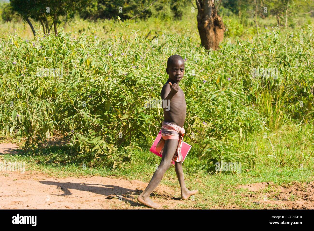 Hamer boy going to school with notebook. Hamer tribe, Omo Valley ...