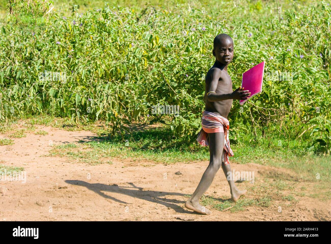 Hamer boy going to school with notebook. Hamer tribe, Omo Valley ...