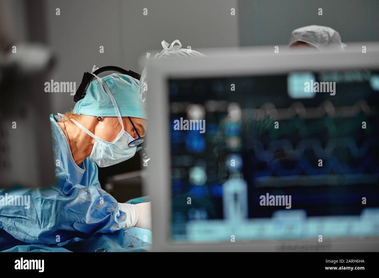 Operating room, portrait of a surgeon between computers Evele and ...