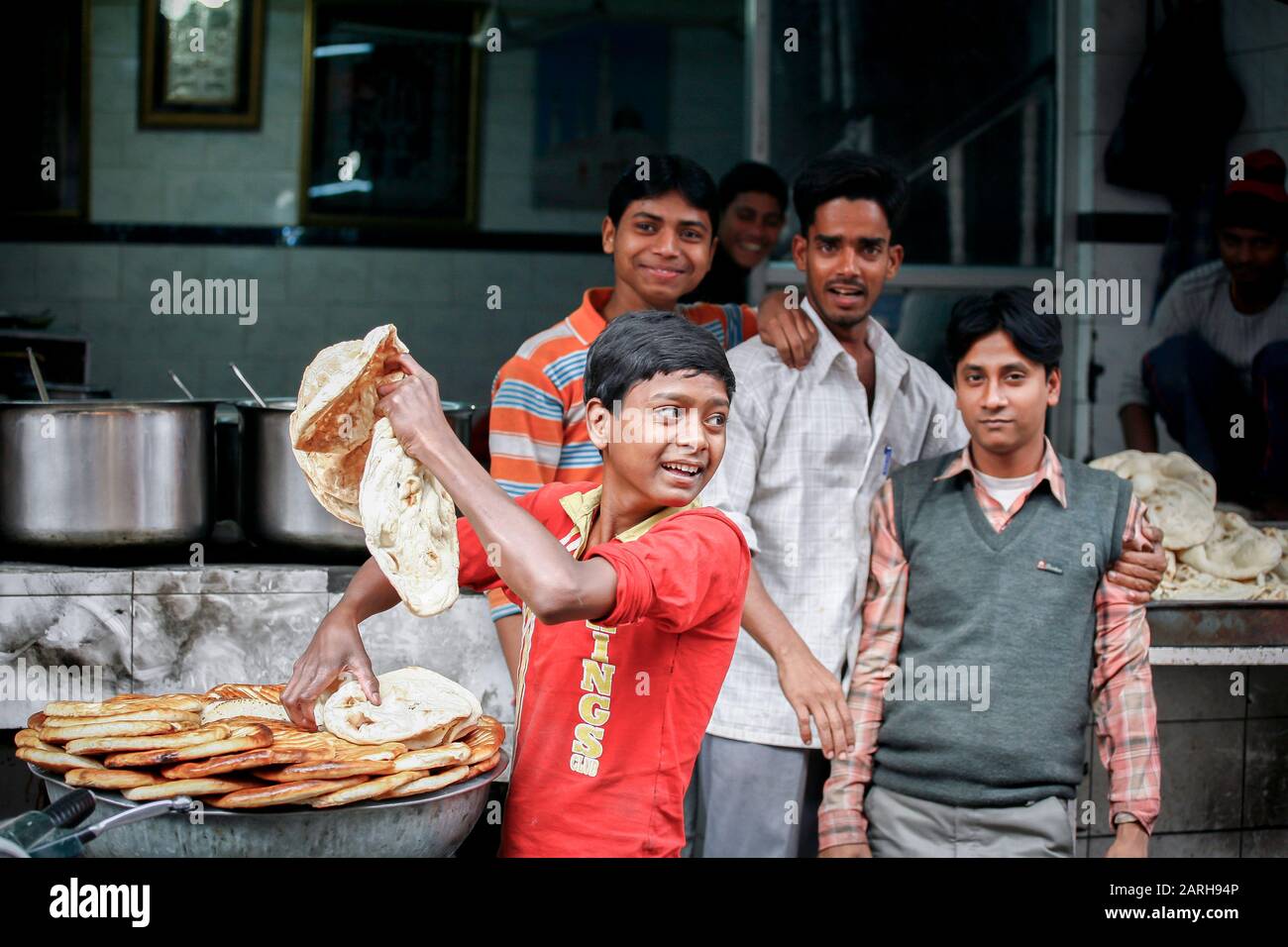 small boys with large chapati Stock Photo - Alamy