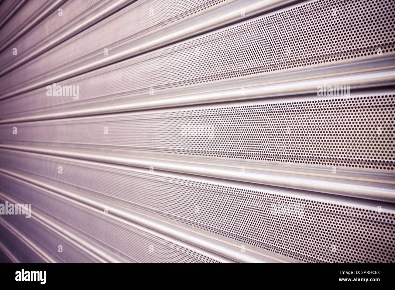 New closed metallic shutter door with perforated sheet Stock Photo - Alamy