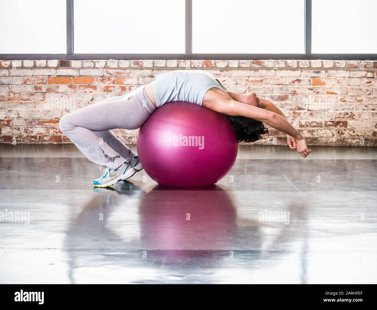 A young woman stretching in a backbend over an exercise ball Stock ...