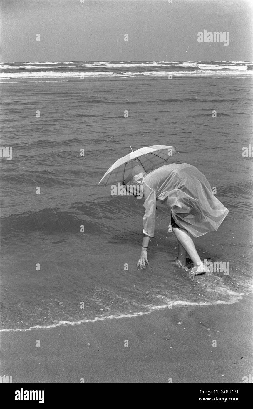 Summer 1966, miss with umbrella and raincoat in sea Date: August 2 ...