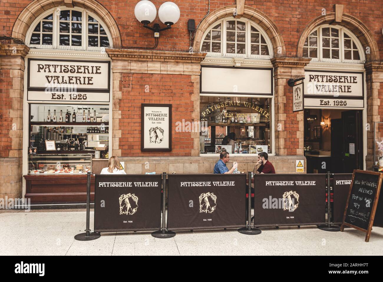 London/UK - 22/07/2019: men talking at the Patisserie Valerie sitting ...