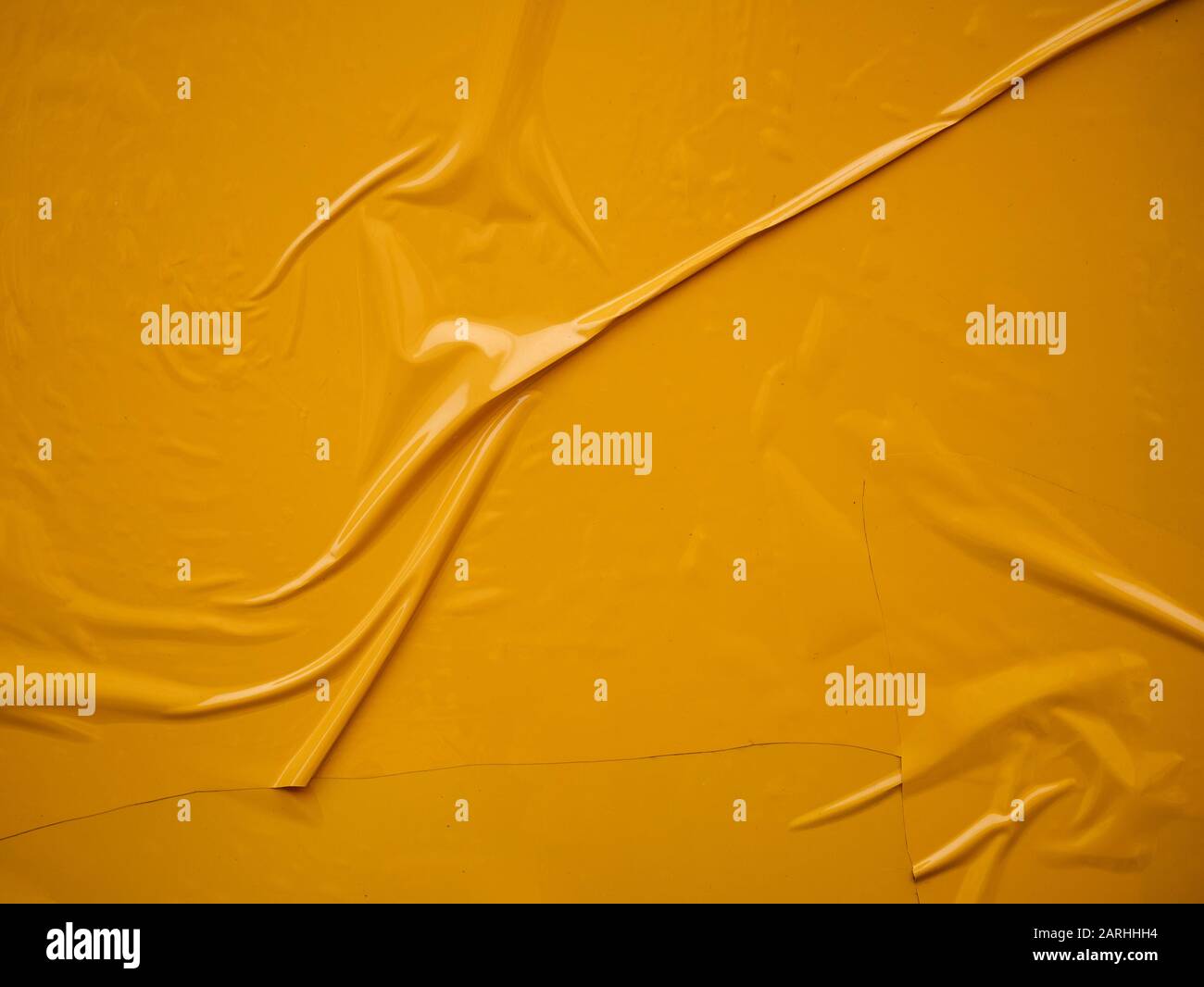Yellow vinyl film overlapped pieces. Background from a film with a wavy ...