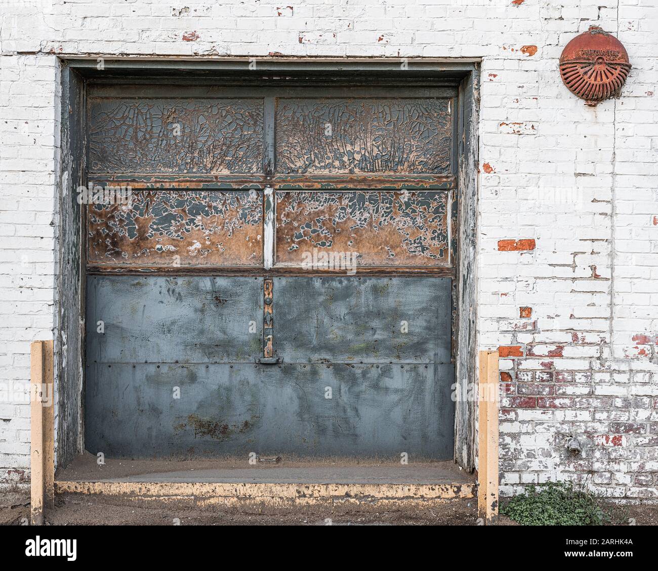 Garage door on an old abandoned industrial building Stock Photo - Alamy