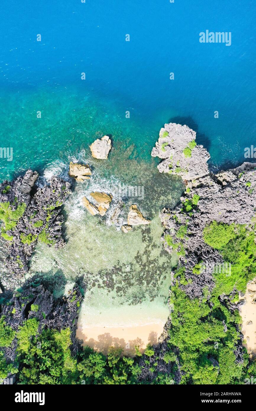 White sand beach on a tropical island, top view. Aerial top view of ...
