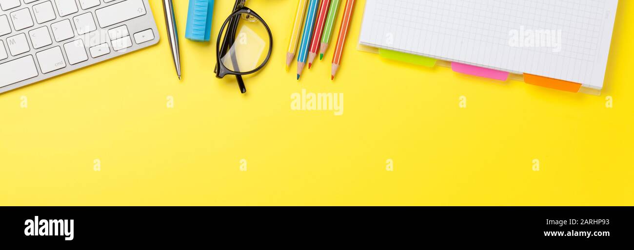 Office yellow workplace backdrop with supplies and computer. Wide flat ...