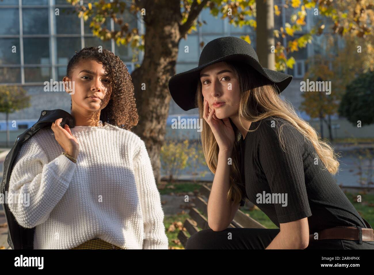 Portrait of two beautiful mexican millennial generation girls. Autumn ...