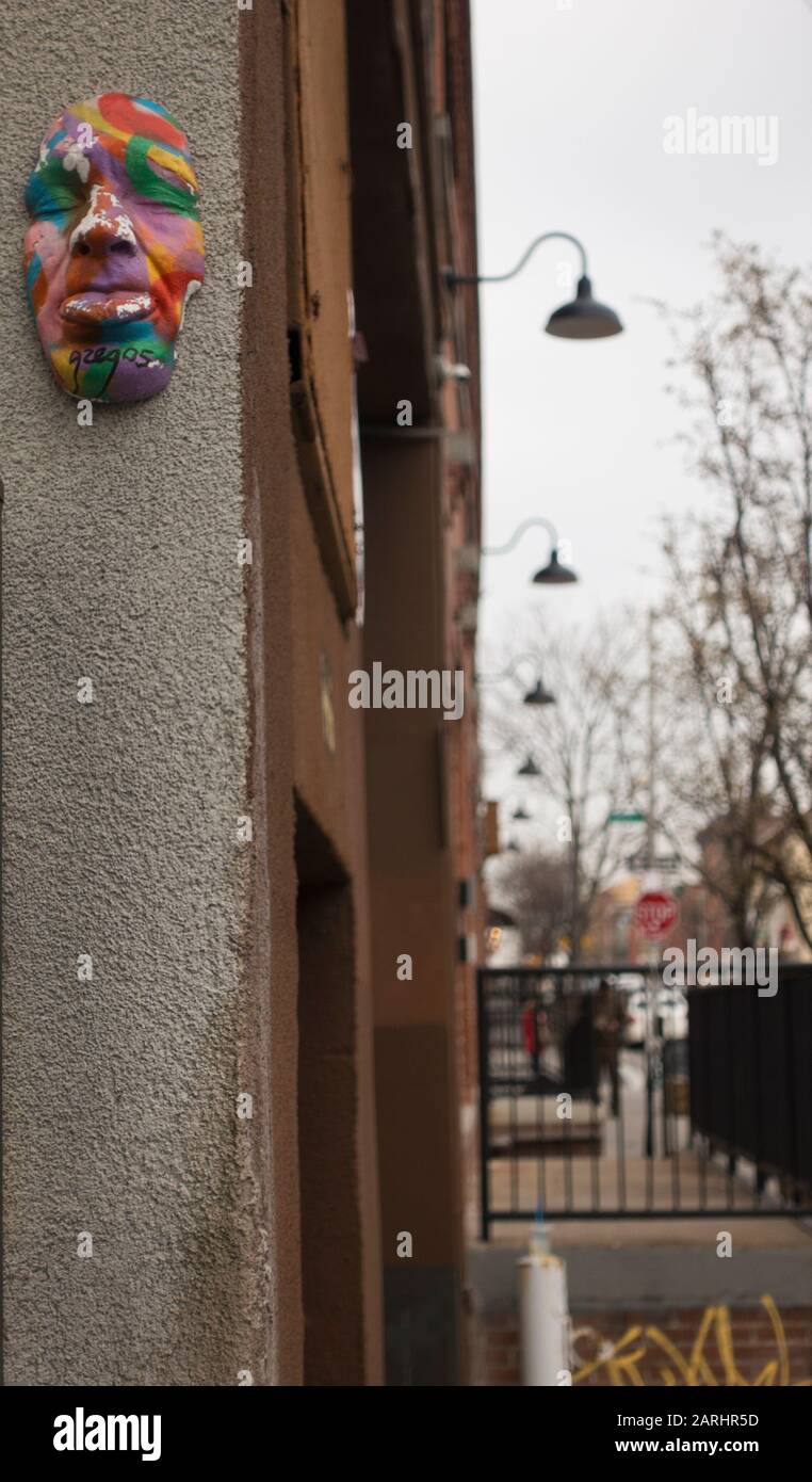 painted face mask on outside of a building in Brooklyn NYC Stock Photo ...