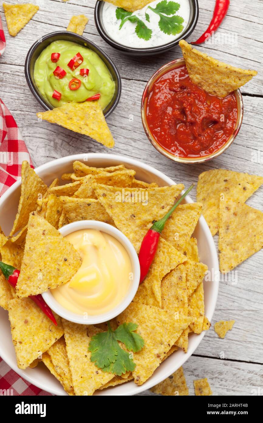Mexican nachos chips with various sauces - guacamole, salsa, cheese and ...