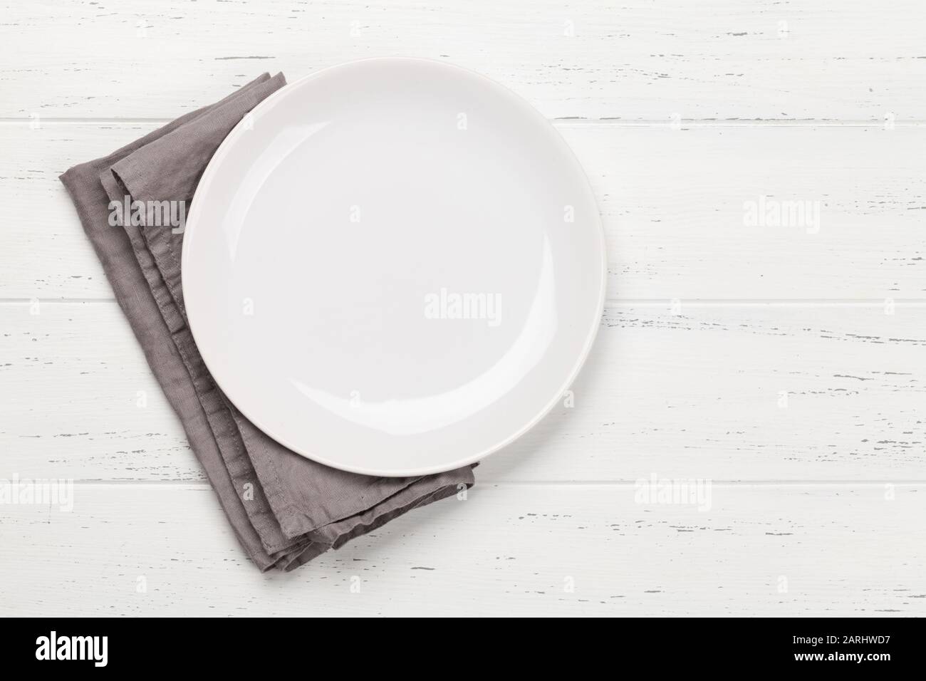 Kitchen table with empty plate, tablecloth and space for your recipe or ...
