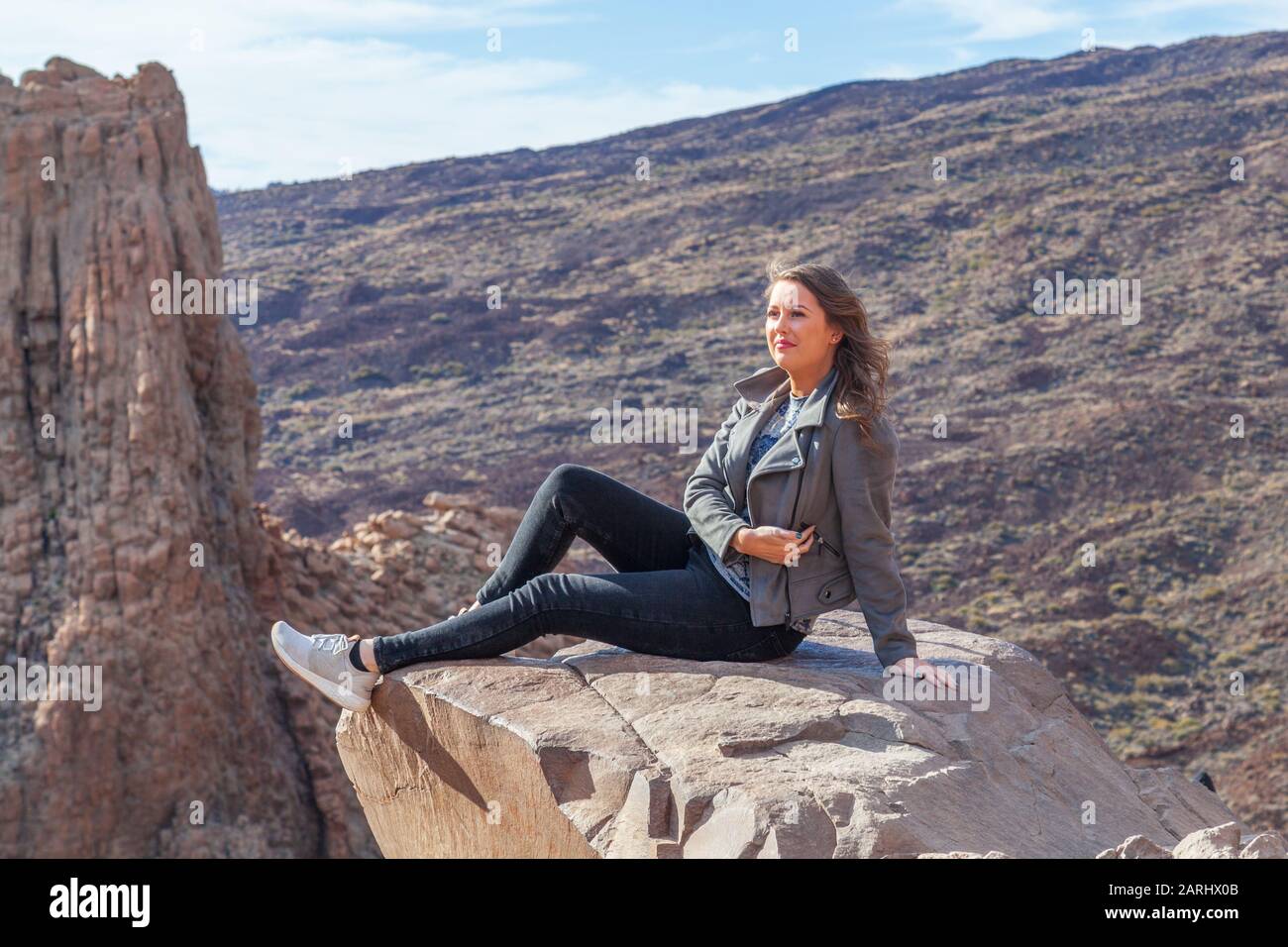 Girl sitting on rock ledge hi-res stock photography and images - Alamy