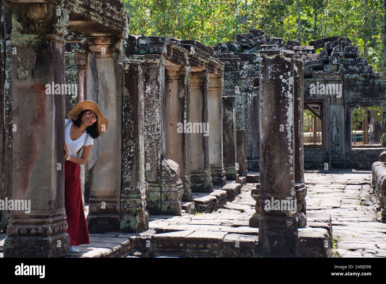 Beautiful, pretty, young Thai girl is exploring the ancient ruins of ...