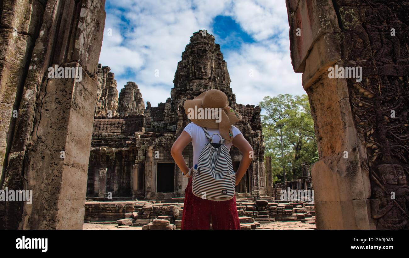 Beautiful, pretty, young Thai girl is exploring the ancient ruins of ...