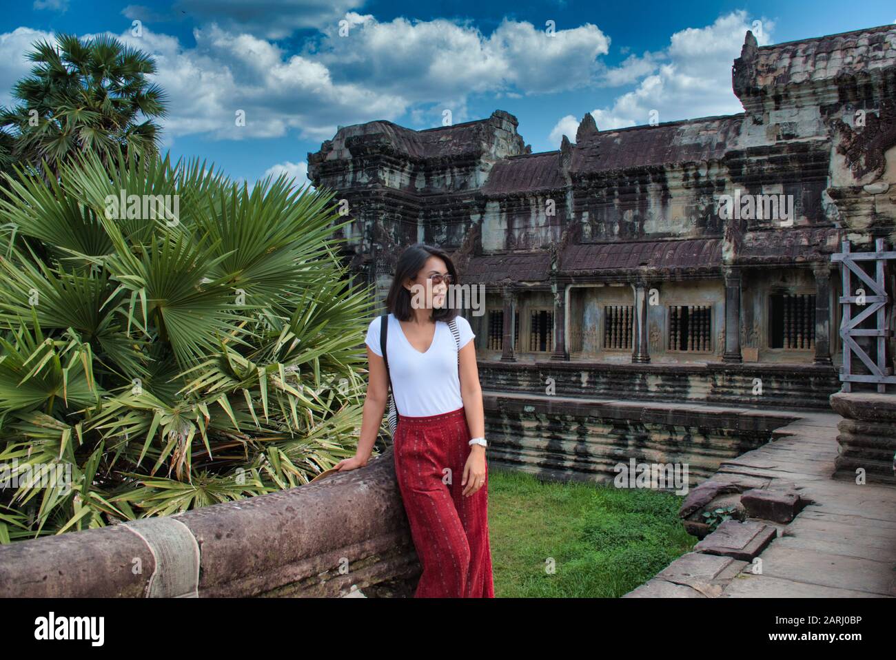 Beautiful, pretty, young Thai girl is exploring the ancient ruins of ...