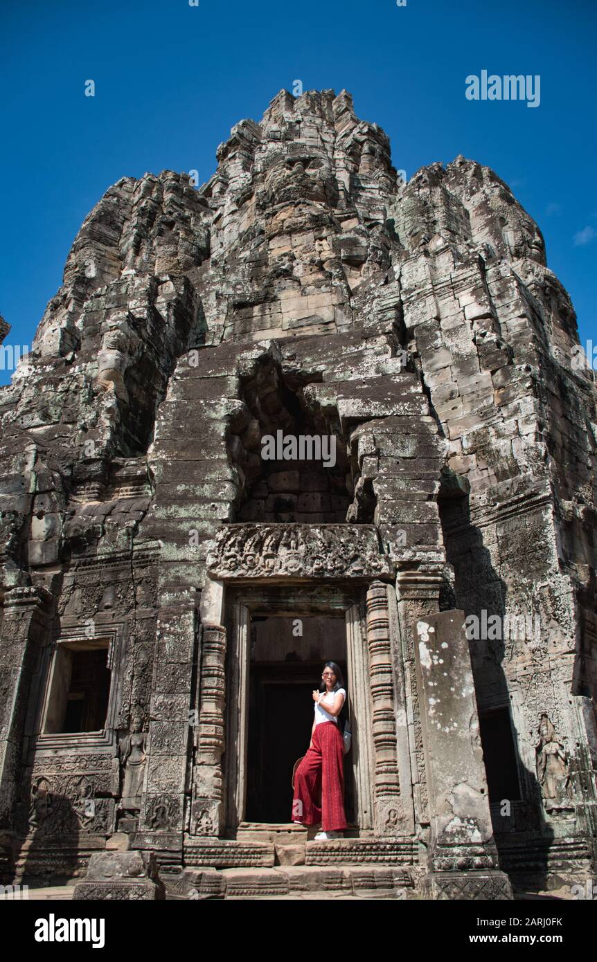 Beautiful, pretty, young Thai girl is exploring the ancient ruins of ...