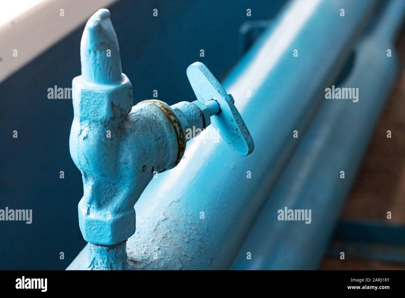 Water pipe with valve painted blue close up, copy space Stock Photo - Alamy