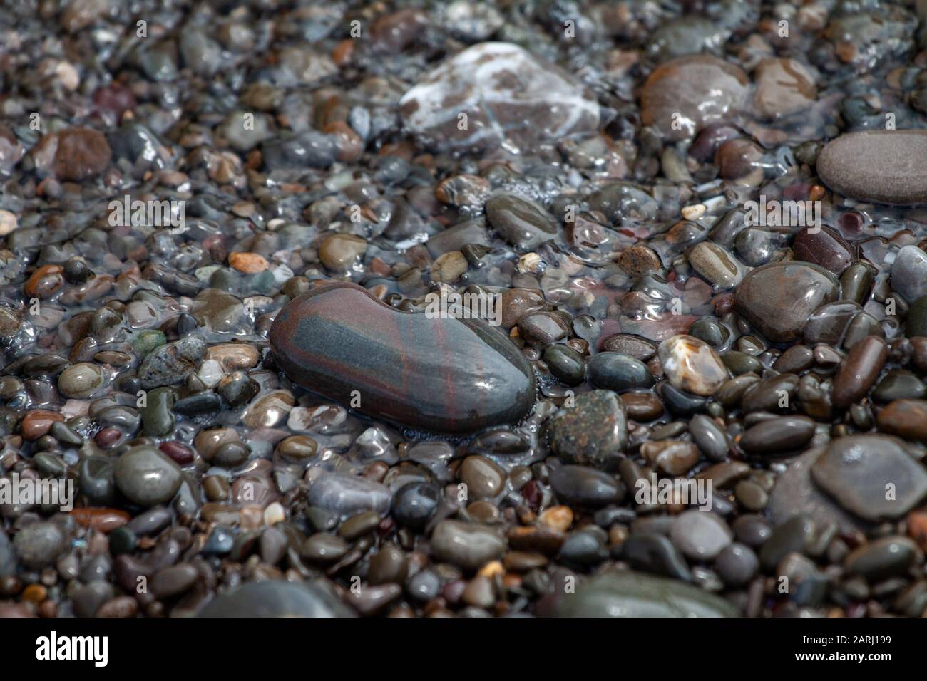 sea pebbles colored granite on the beach background stones. The shore ...