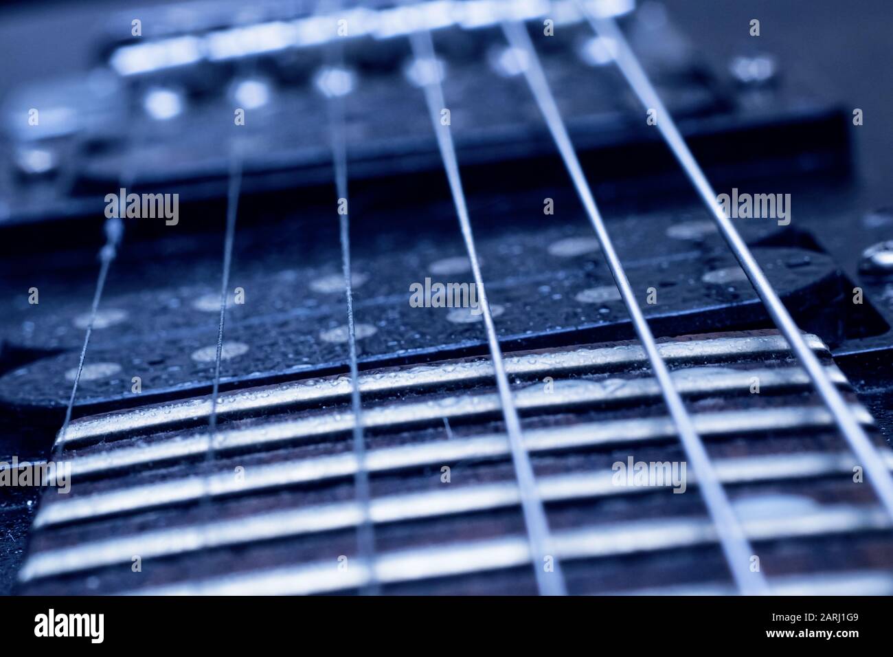 Strings on a black guitar close up, macro photo Stock Photo - Alamy