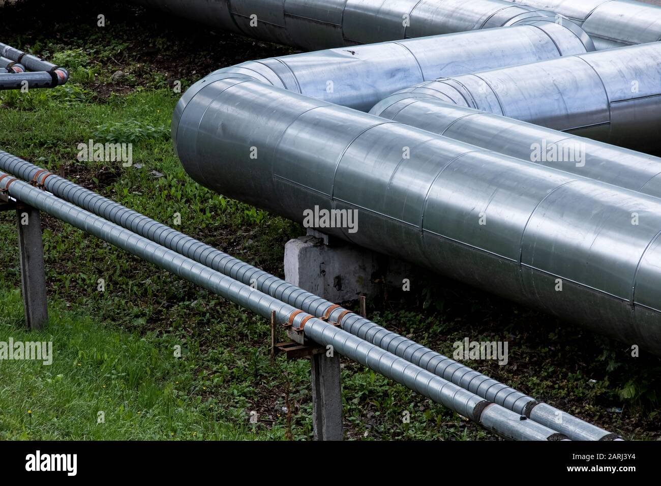 Metal water pipes above the ground close up, industrial elements Stock ...