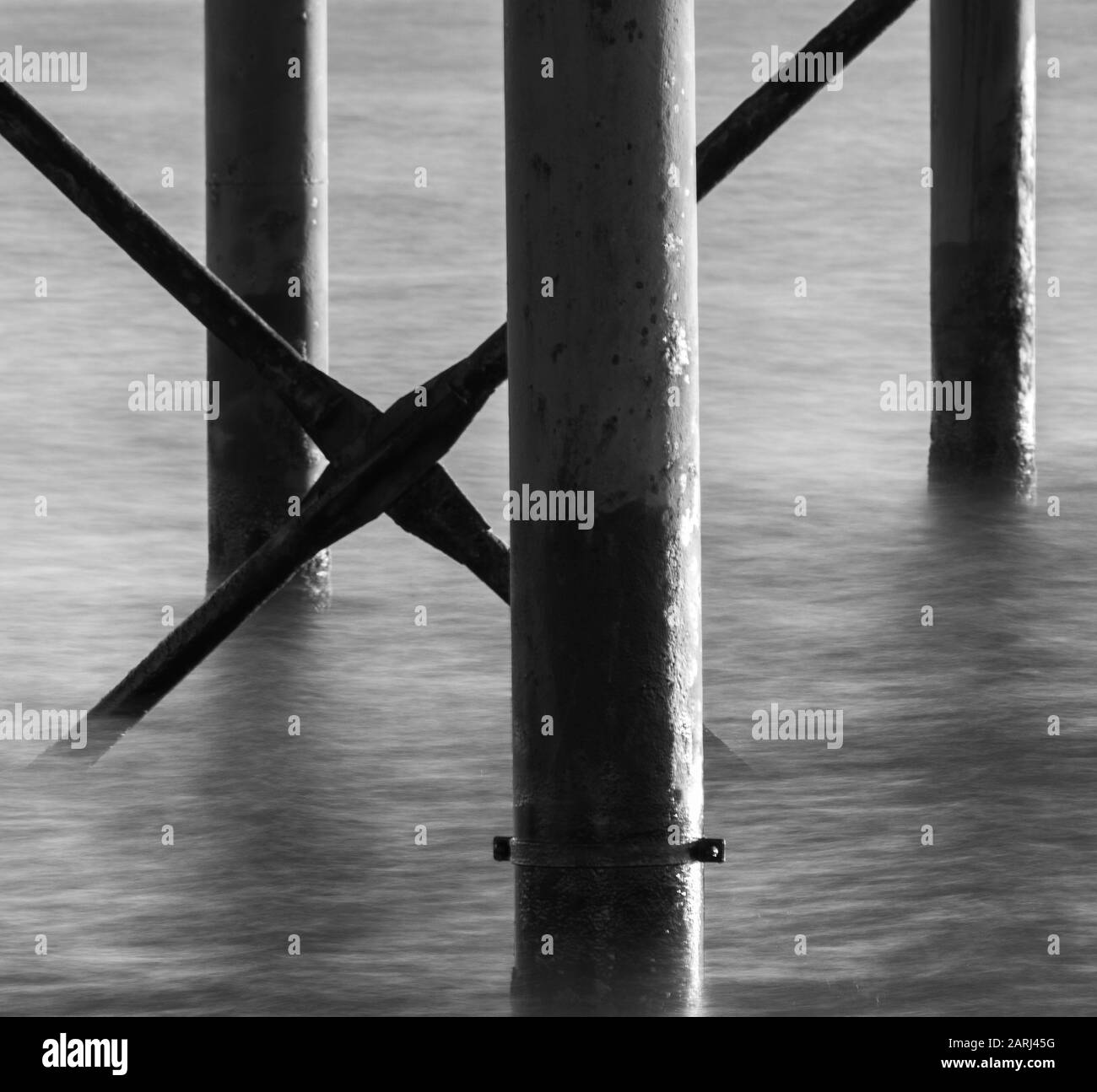 The old Victorian pier legs at high tide on Paignton beach at dawn ...