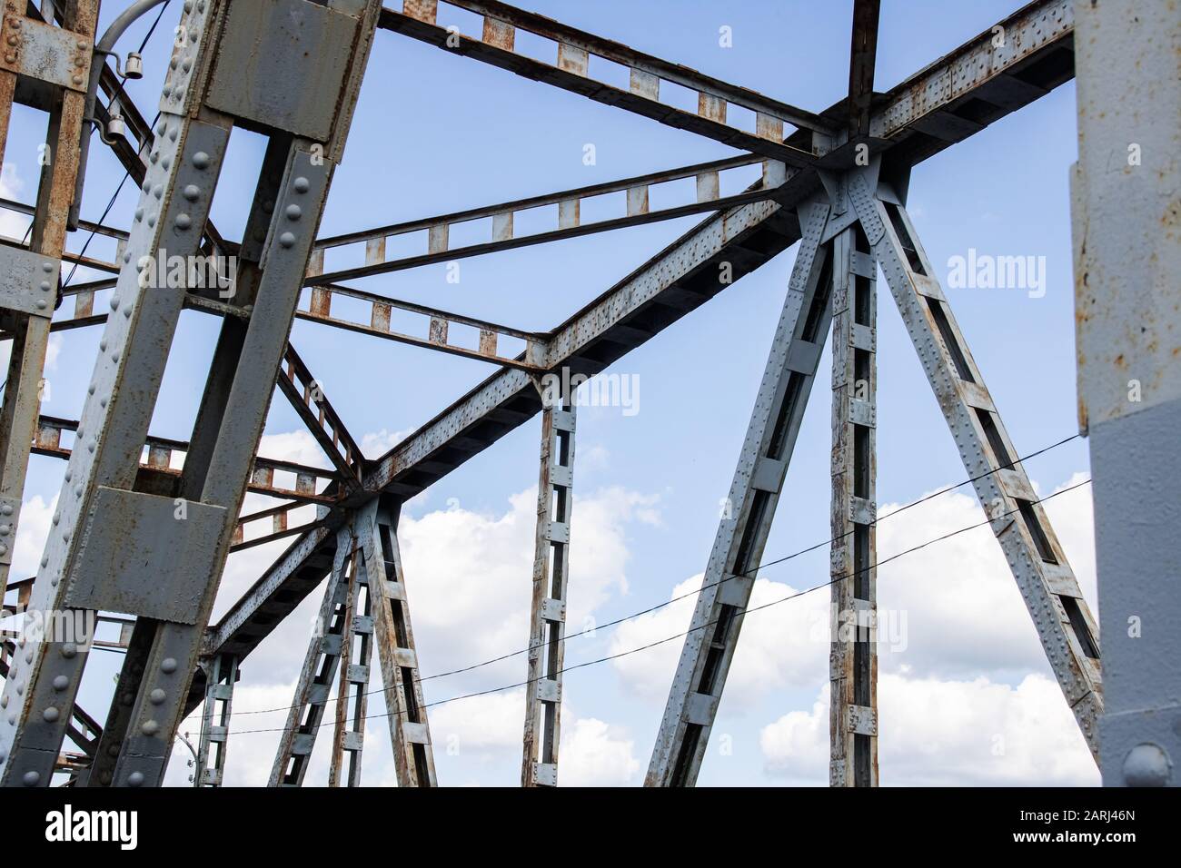 Metal beams on the sky with clouds background close up Stock Photo - Alamy