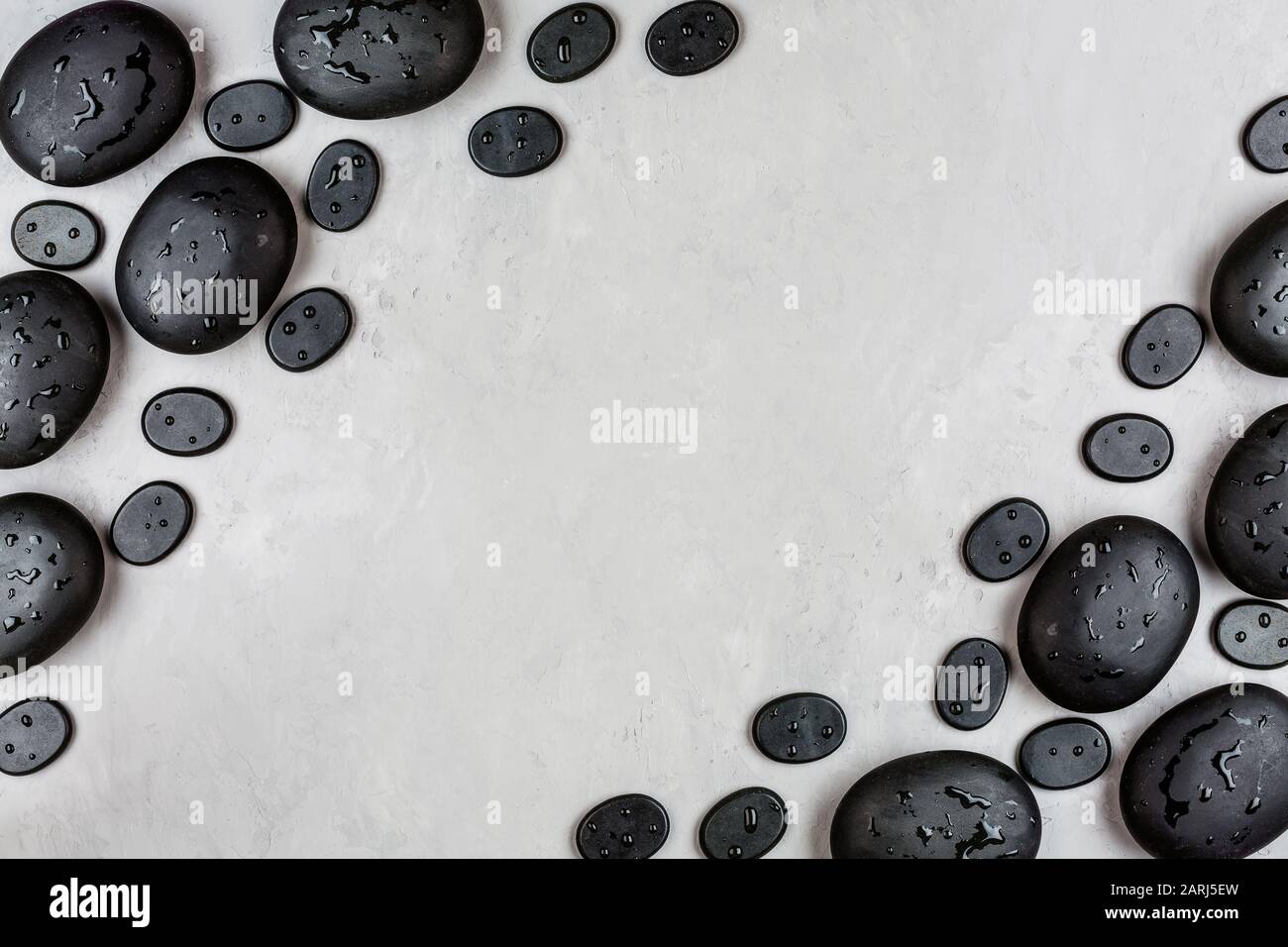 Top view of hot spa stones set for massage treatment on gray concrete ...