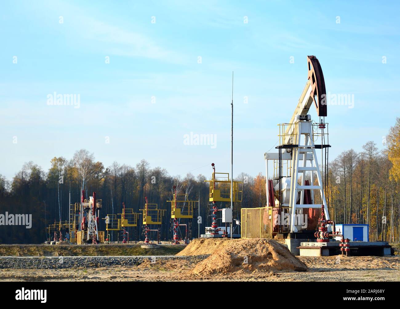 Oil drilling derricks at desert oilfield for fossil fuels output and ...