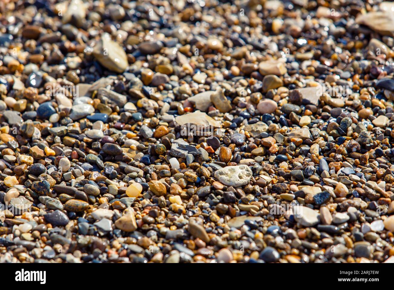 small round wet sea pebbles on the beach Stock Photo - Alamy