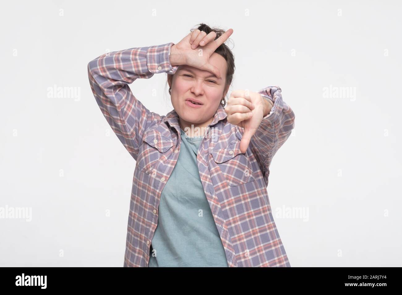 You are outsider. Annoyed good looking woman, tilting head and showing ...