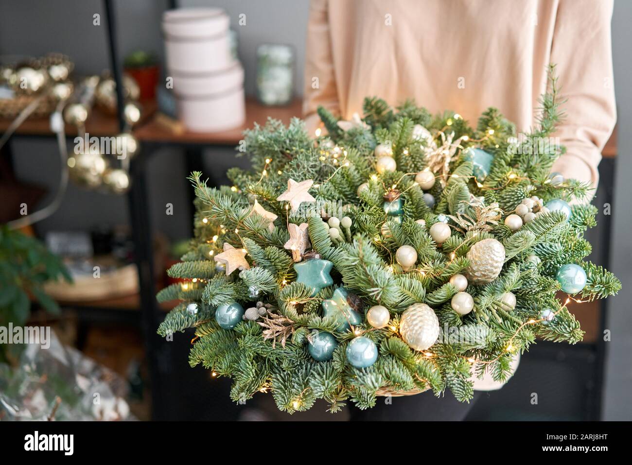 Big arrangement of fresh spruce in a wicker basket. Christmas mood ...