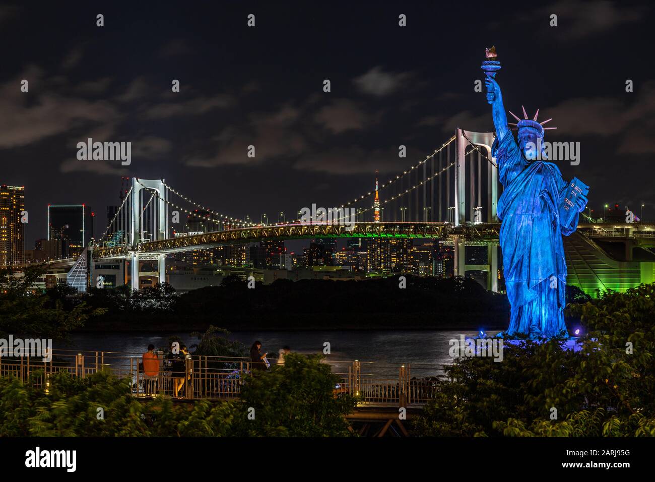 Night view of Statue of Liberty replica and Rainbow Bridge connecting ...