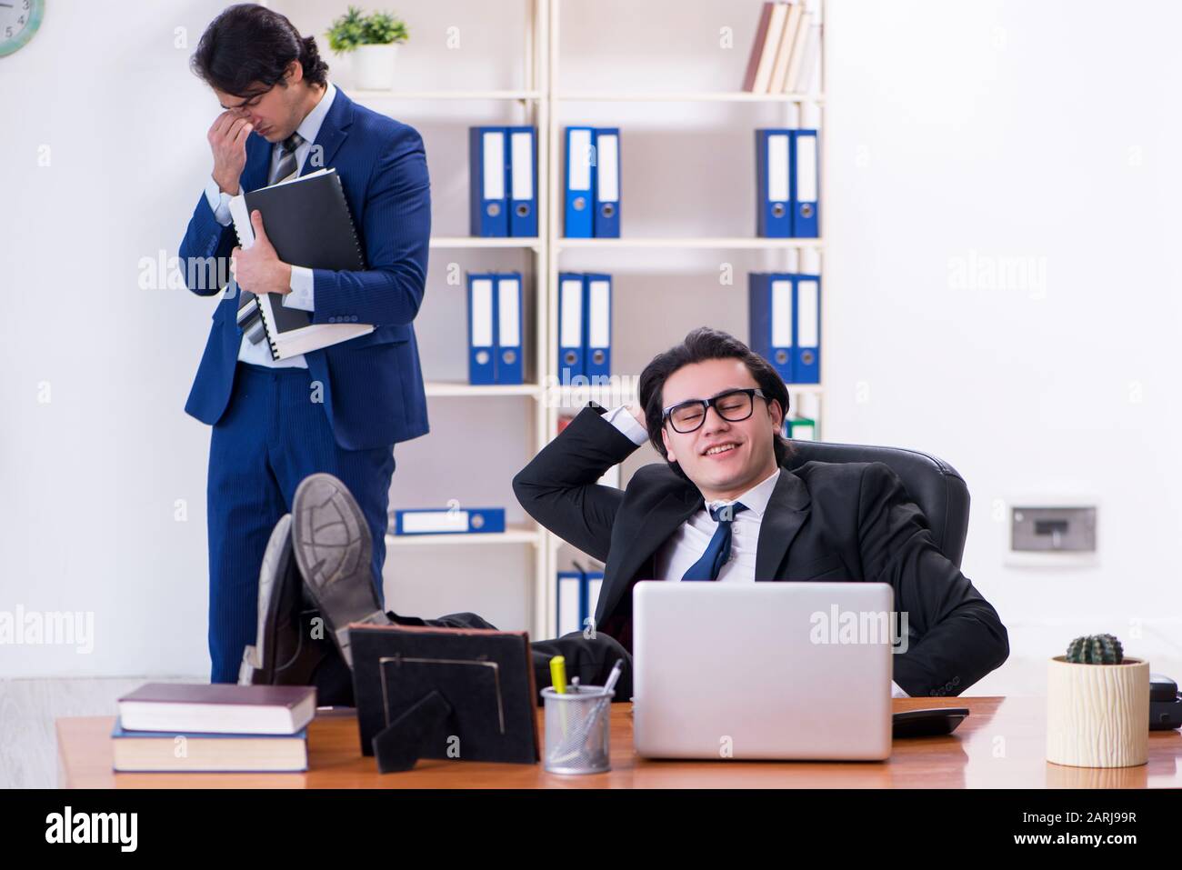 The boss and his male assistant working in the office Stock Photo - Alamy