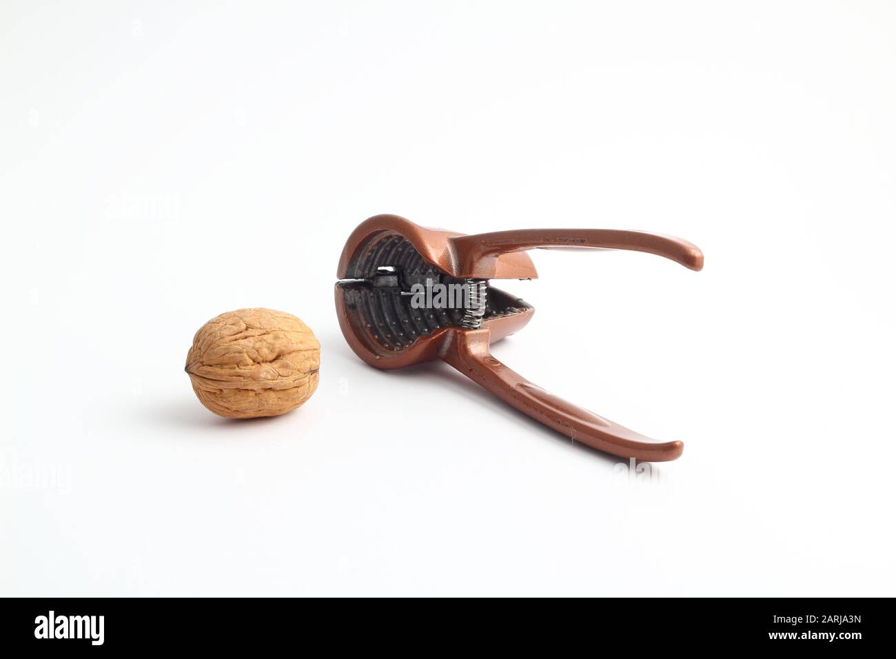 Walnuts with nutcracker isolated on white background Stock Photo - Alamy