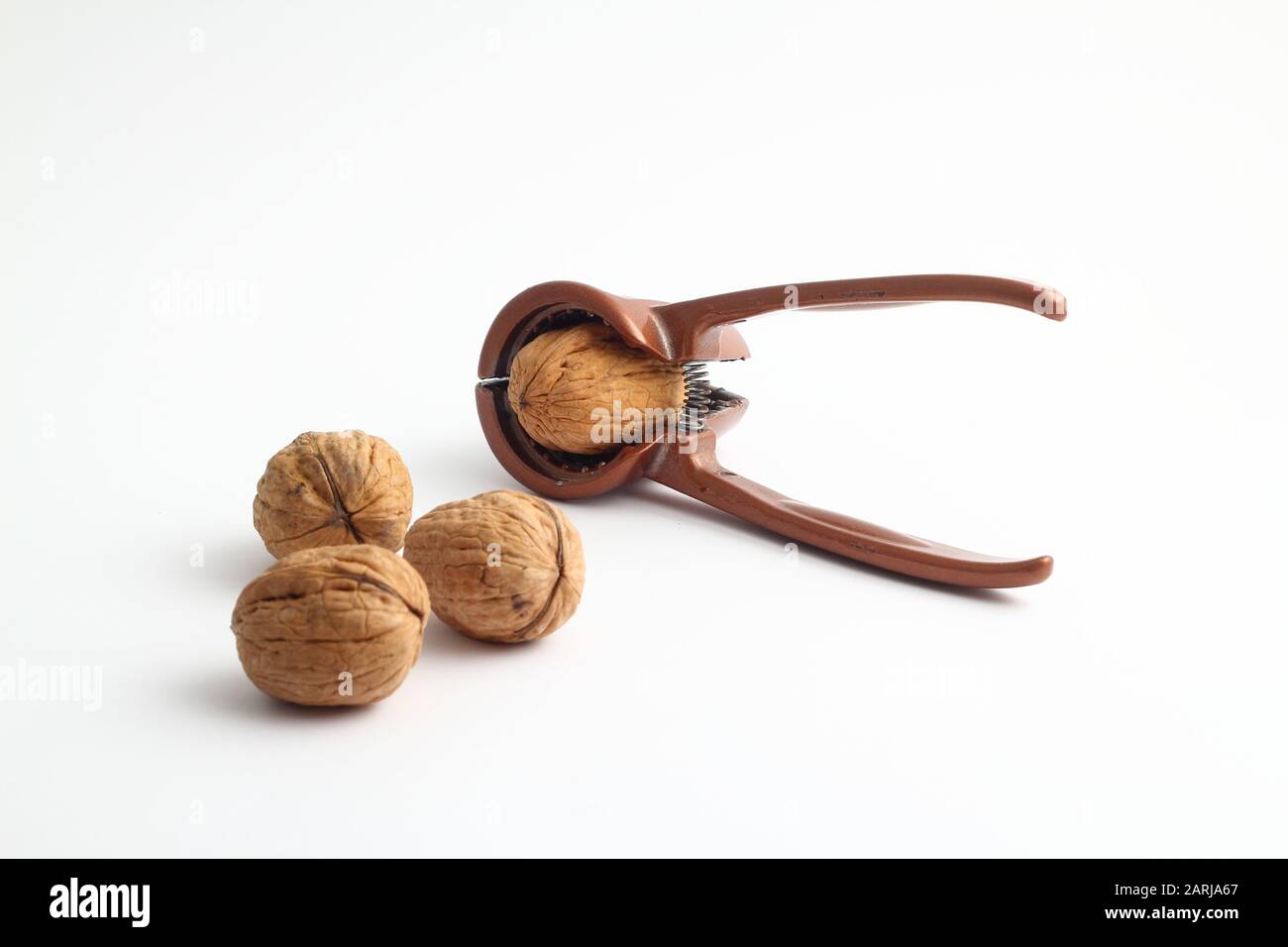 Walnuts with nutcracker isolated on white background Stock Photo - Alamy