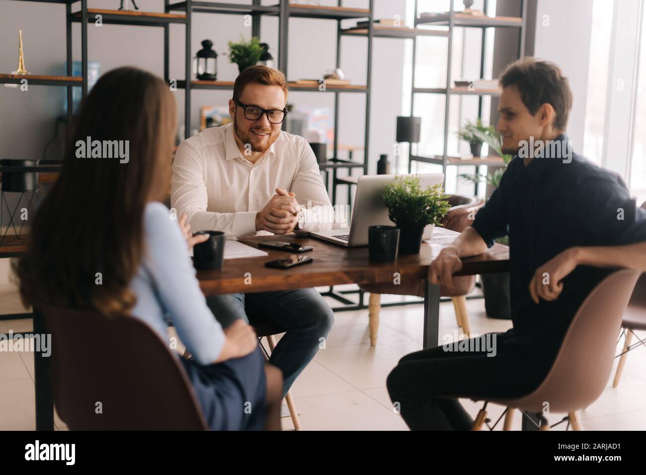 Business team coworkers talking at work, discussing new project ideas ...