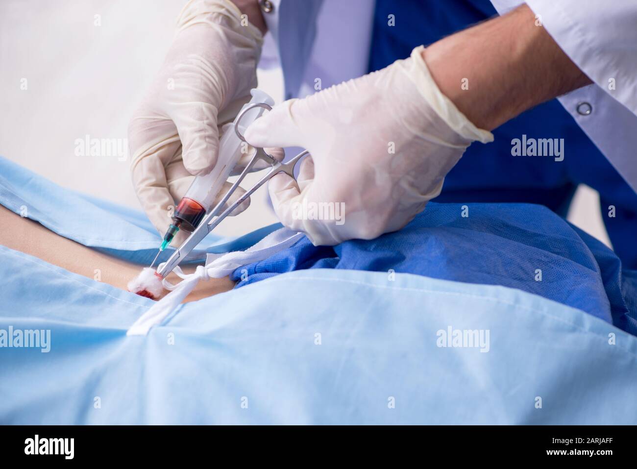 The female patient getting an injection in the clinic Stock Photo - Alamy