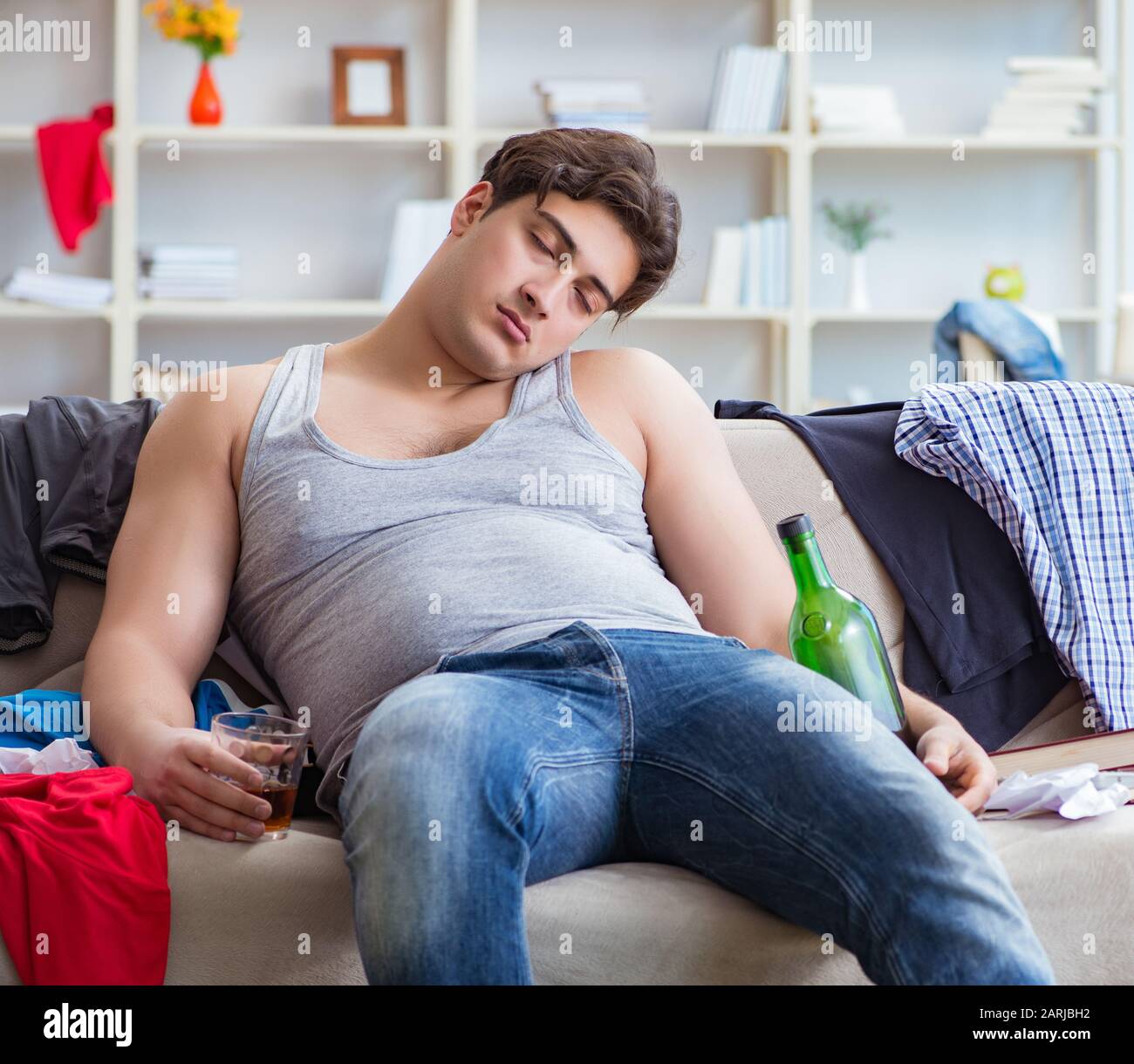 The young man student drunk drinking alcohol in a messy room Stock ...