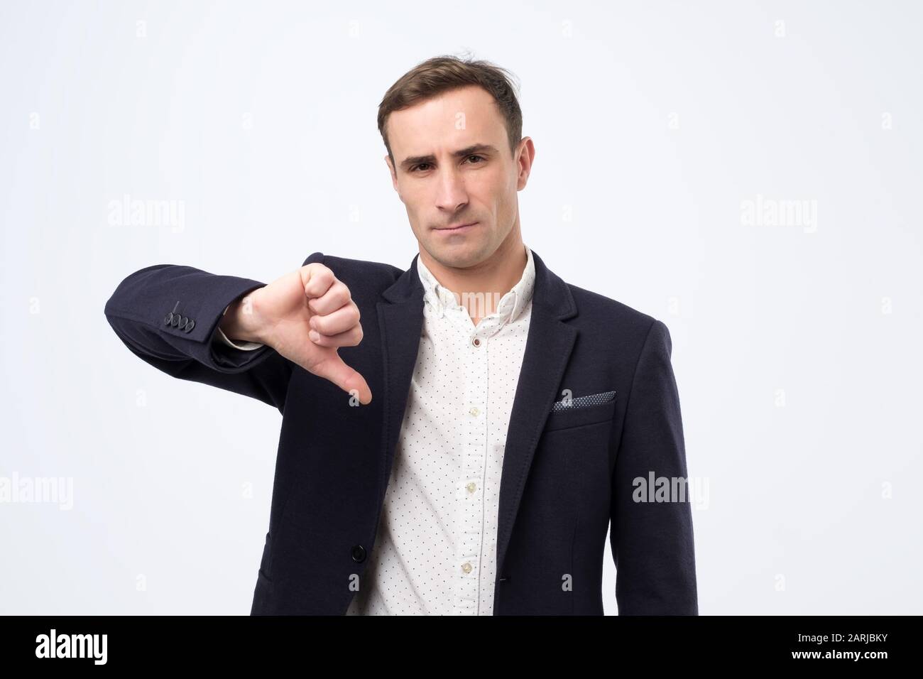 young businessman shows thumb down gesture. Unhappy, sad boss is upset ...