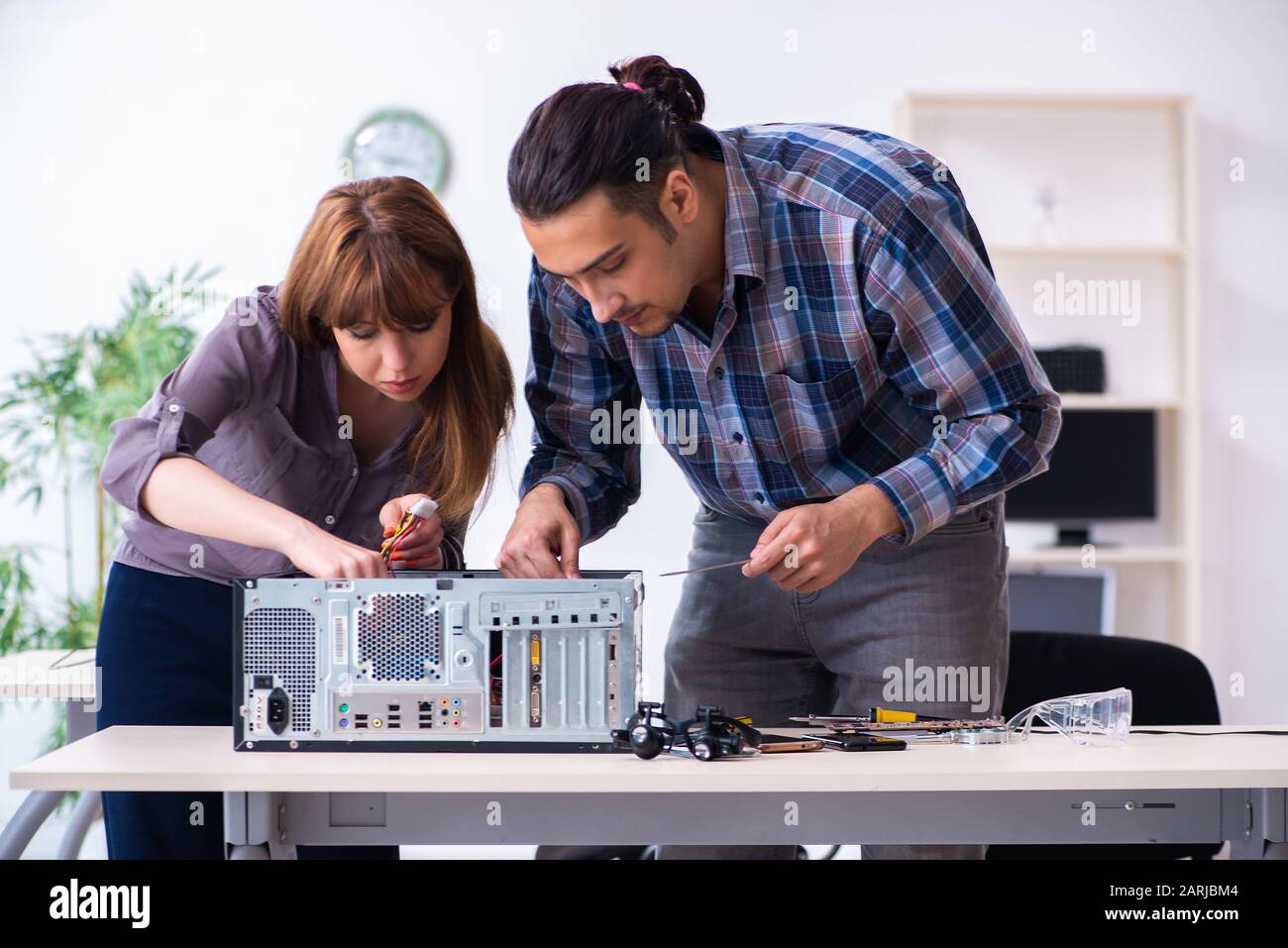 The two repairmen repairing desktop computer Stock Photo - Alamy