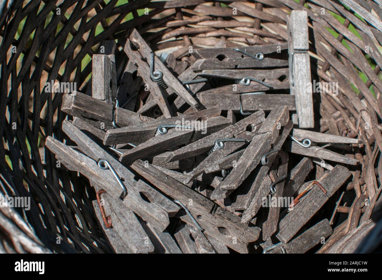Pile of weathered wooden laundry clamps closeup in reed basket Stock ...
