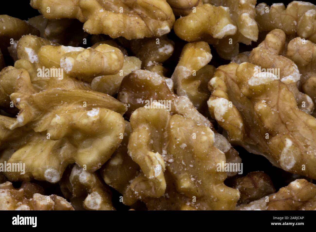 Walnut halves and pieces close up view Stock Photo - Alamy