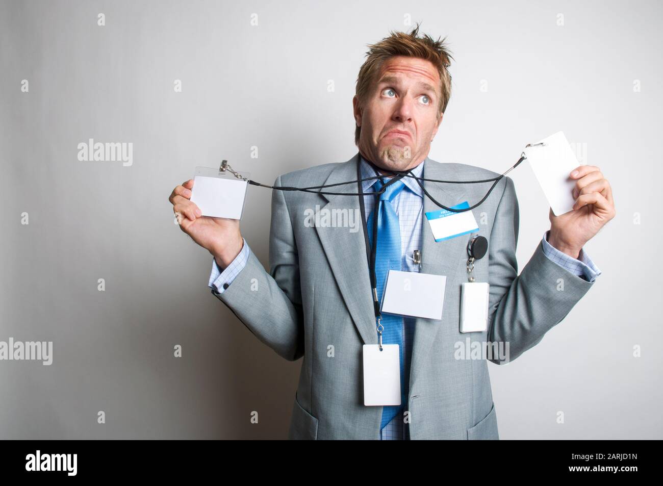 Confused office worker indundated with blank name tags making a funny ...